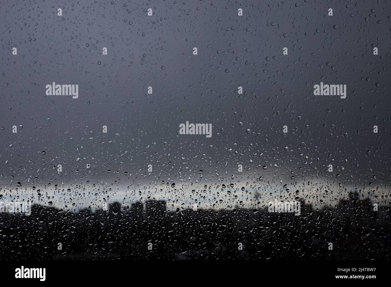 drops water on wet glass window in rainy day. rain outside window ...