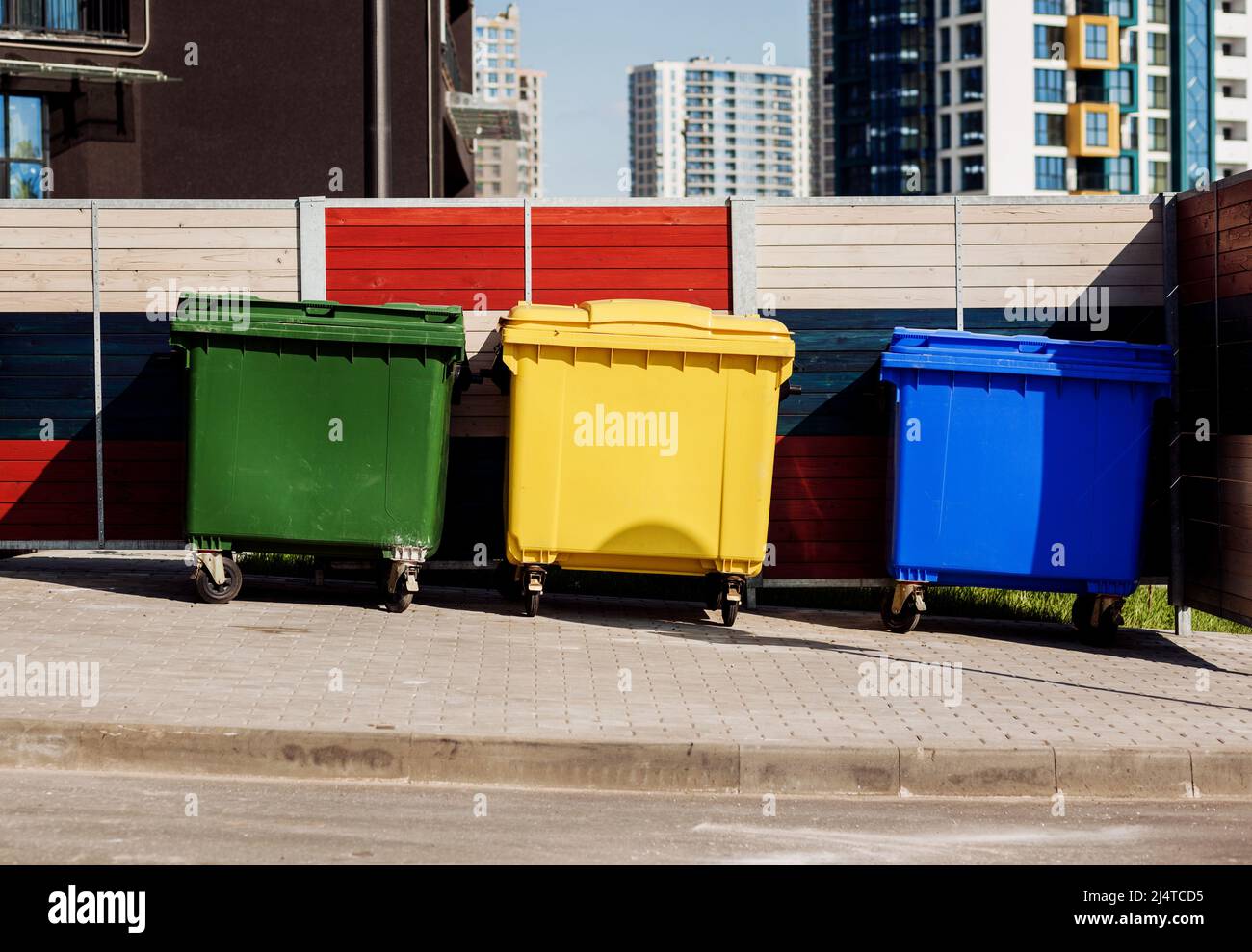 Many colored Residential Garbage Containers On The Street For Pickup ...