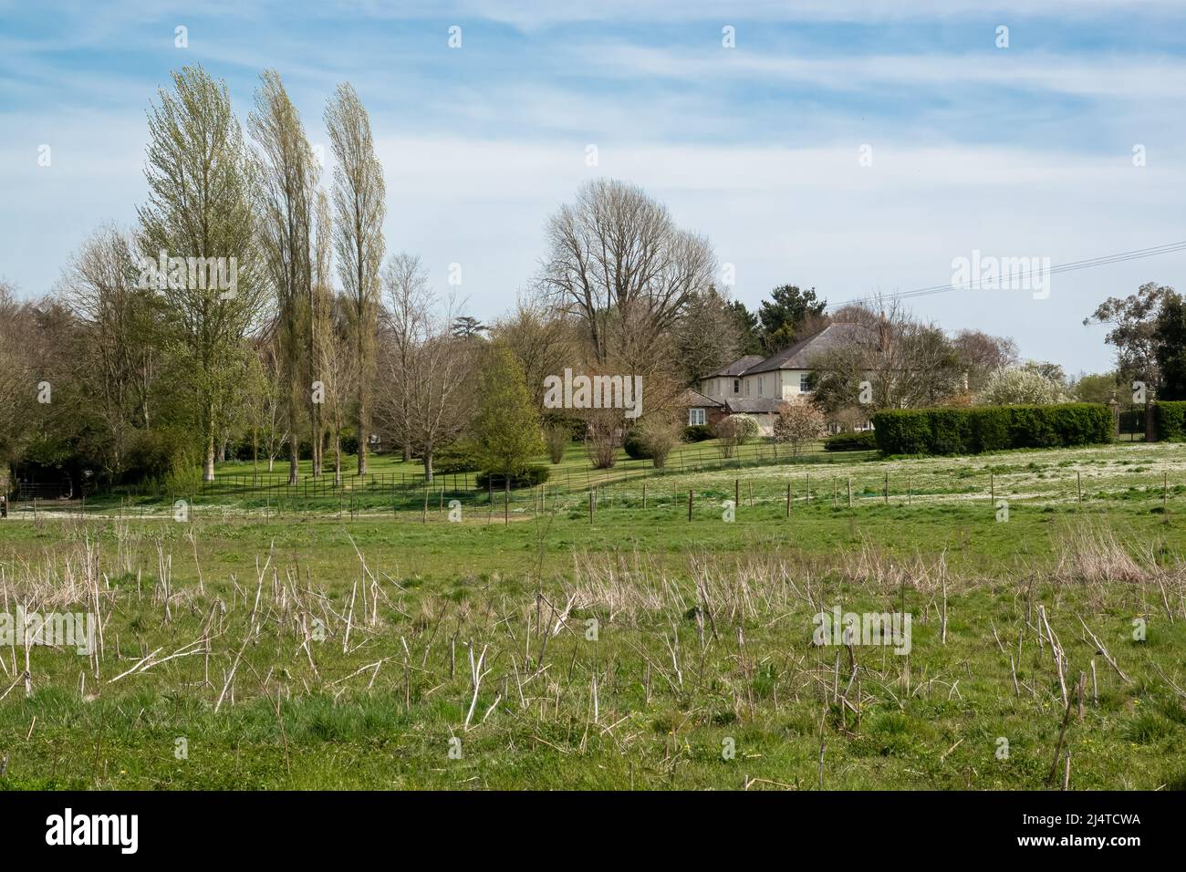 looking across meadows and a paddock to an English period country house ...