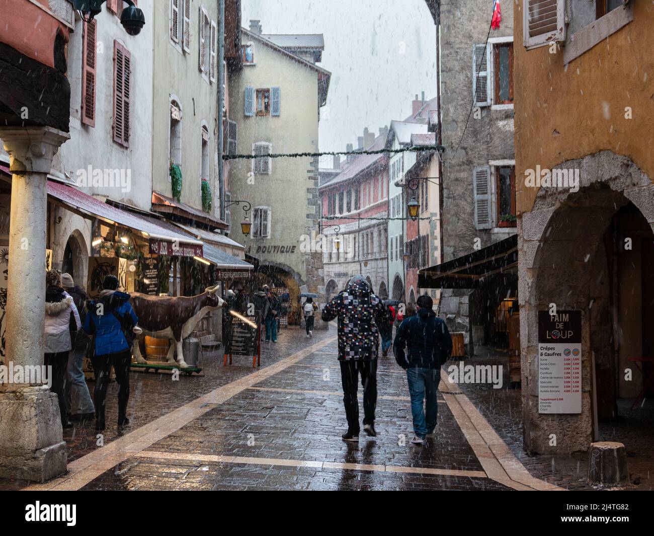 Annecy, France - January 7, 2022: People walking in snowy winter ...