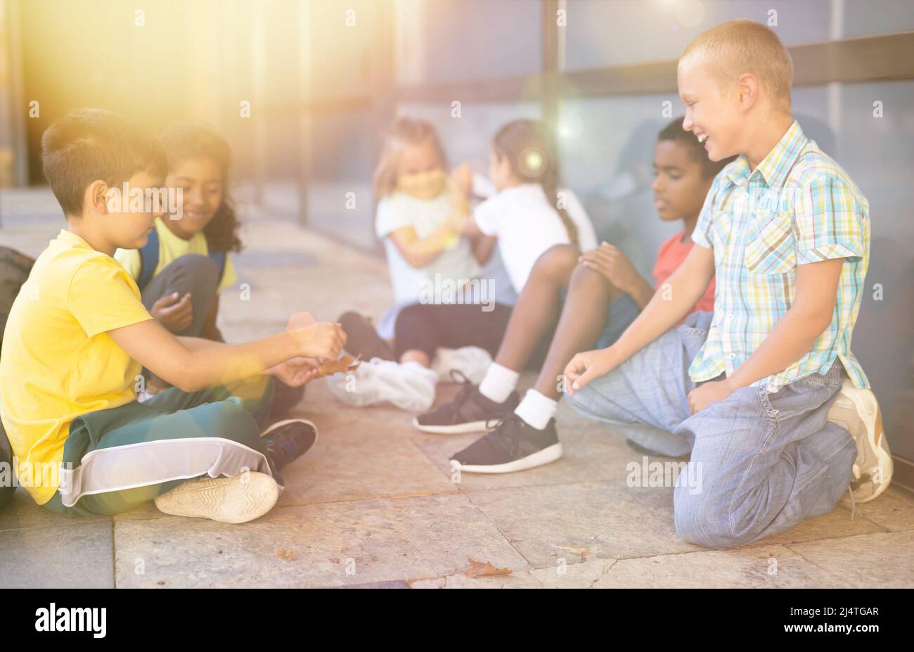 Group of primary schoolchildren talking outside Stock Photo - Alamy
