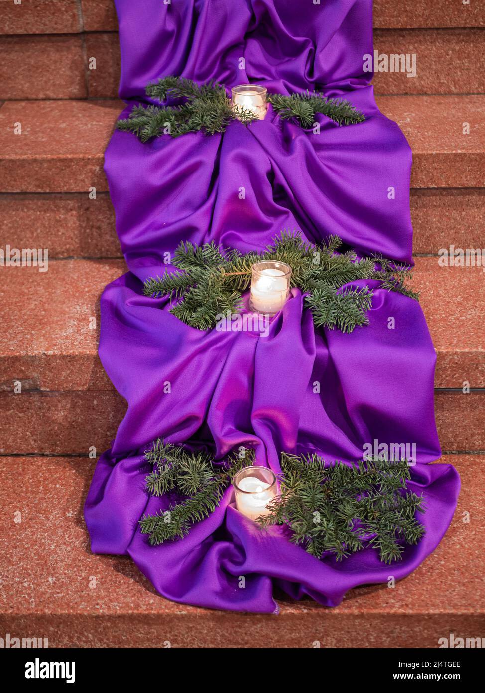 Funeral floor decoration with burning candles and purple cloth in the ...