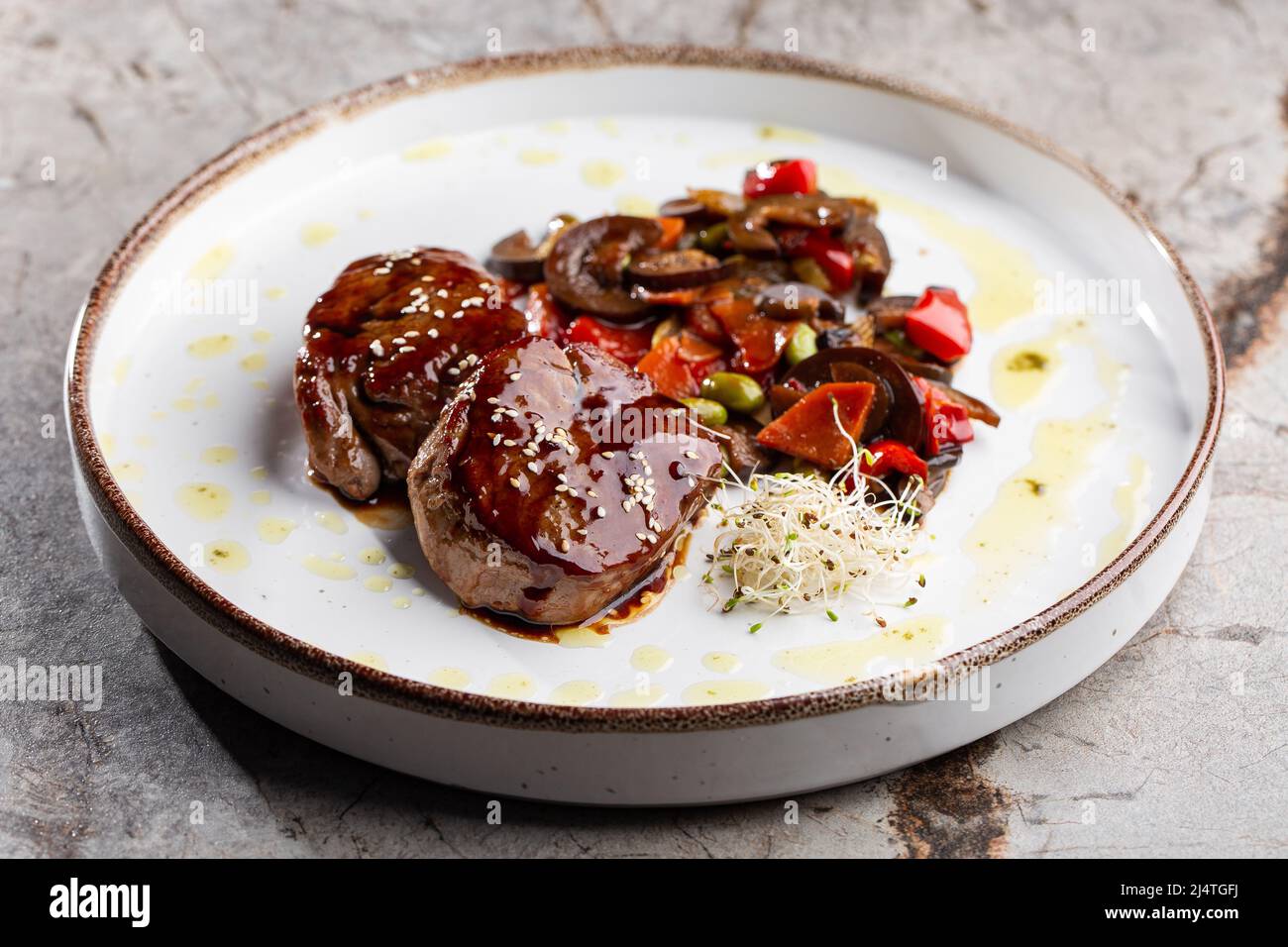 Grilled meat fillet steak wrapped in bacon medallions with raspberry ...