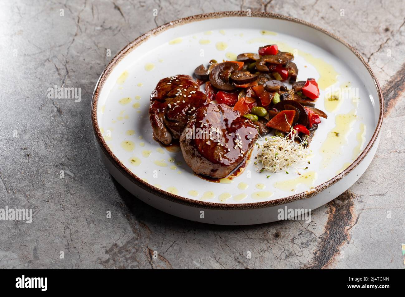 Grilled meat fillet steak wrapped in bacon medallions with raspberry ...