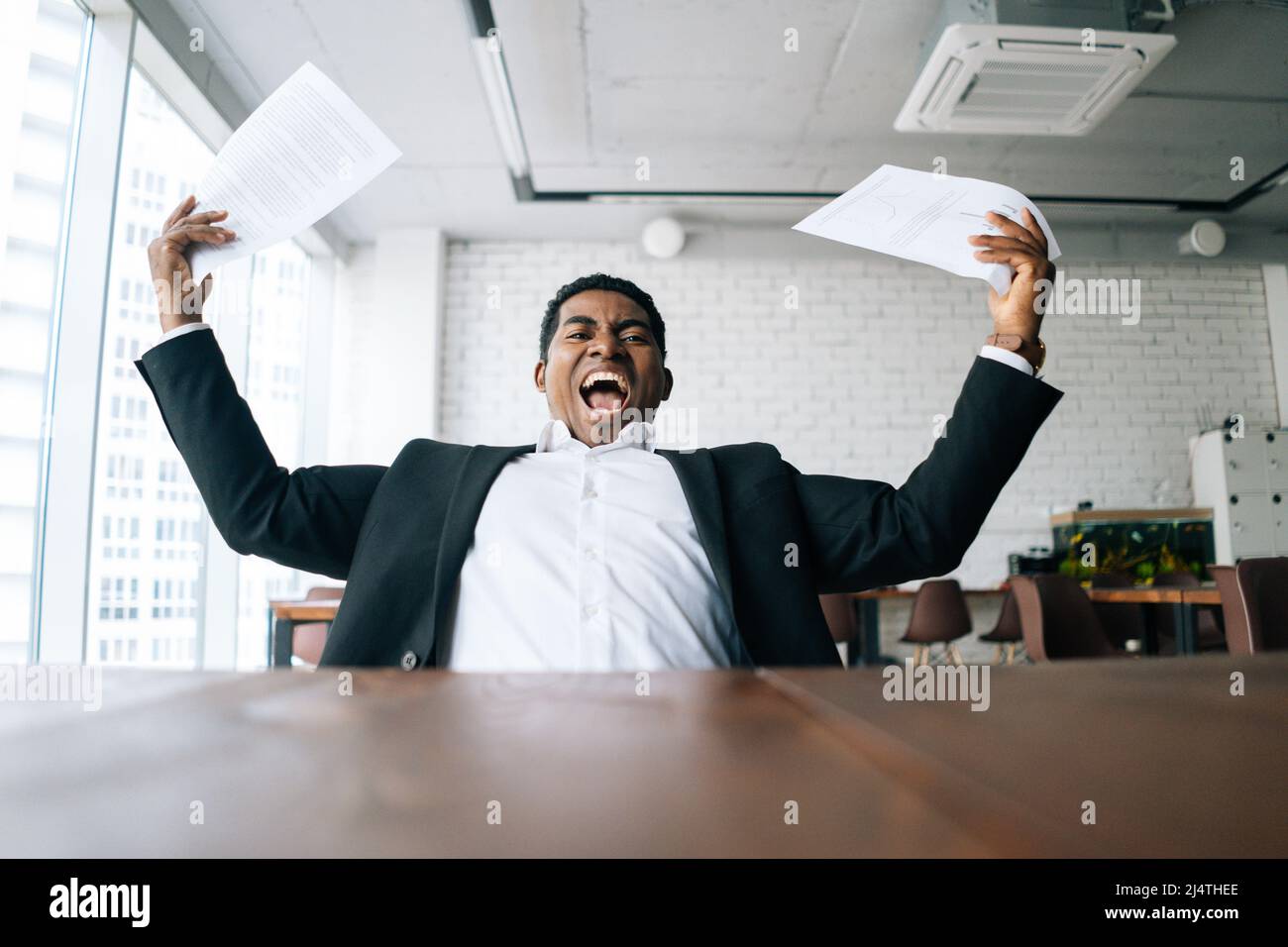 Close-up low-angle view of nervous excited African American business ...