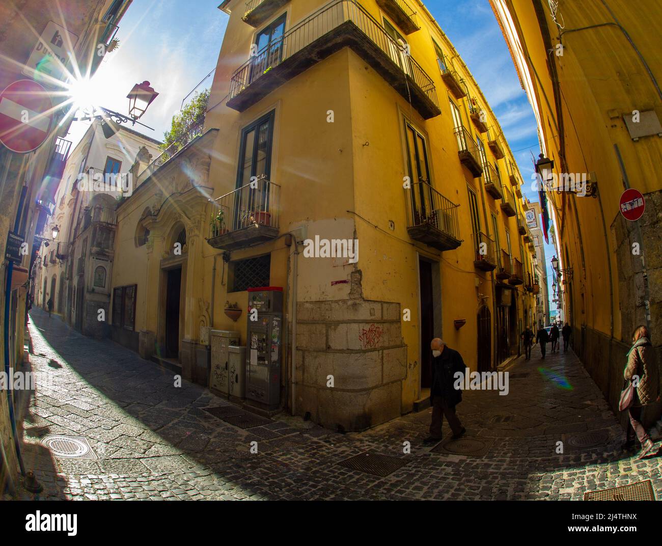 Thin cobbled streets in Salerno Italy with old buildings and lots of ...