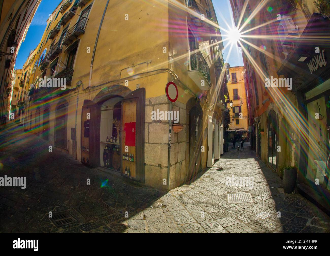 Thin cobbled streets in Salerno Italy with old buildings and lots of ...
