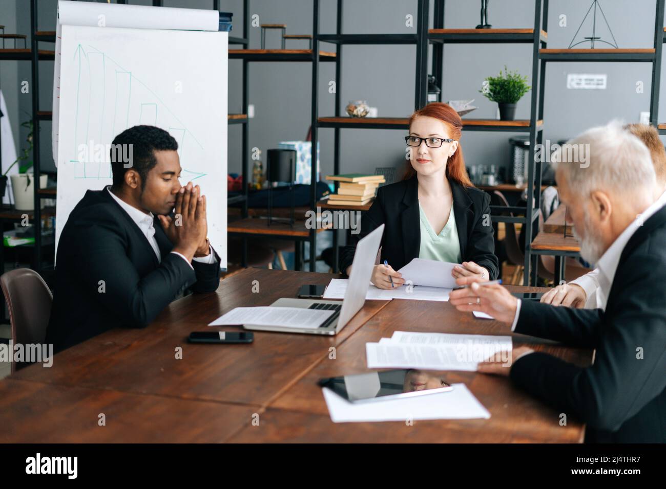 Team of multiracial business people listening female leader explaining ...