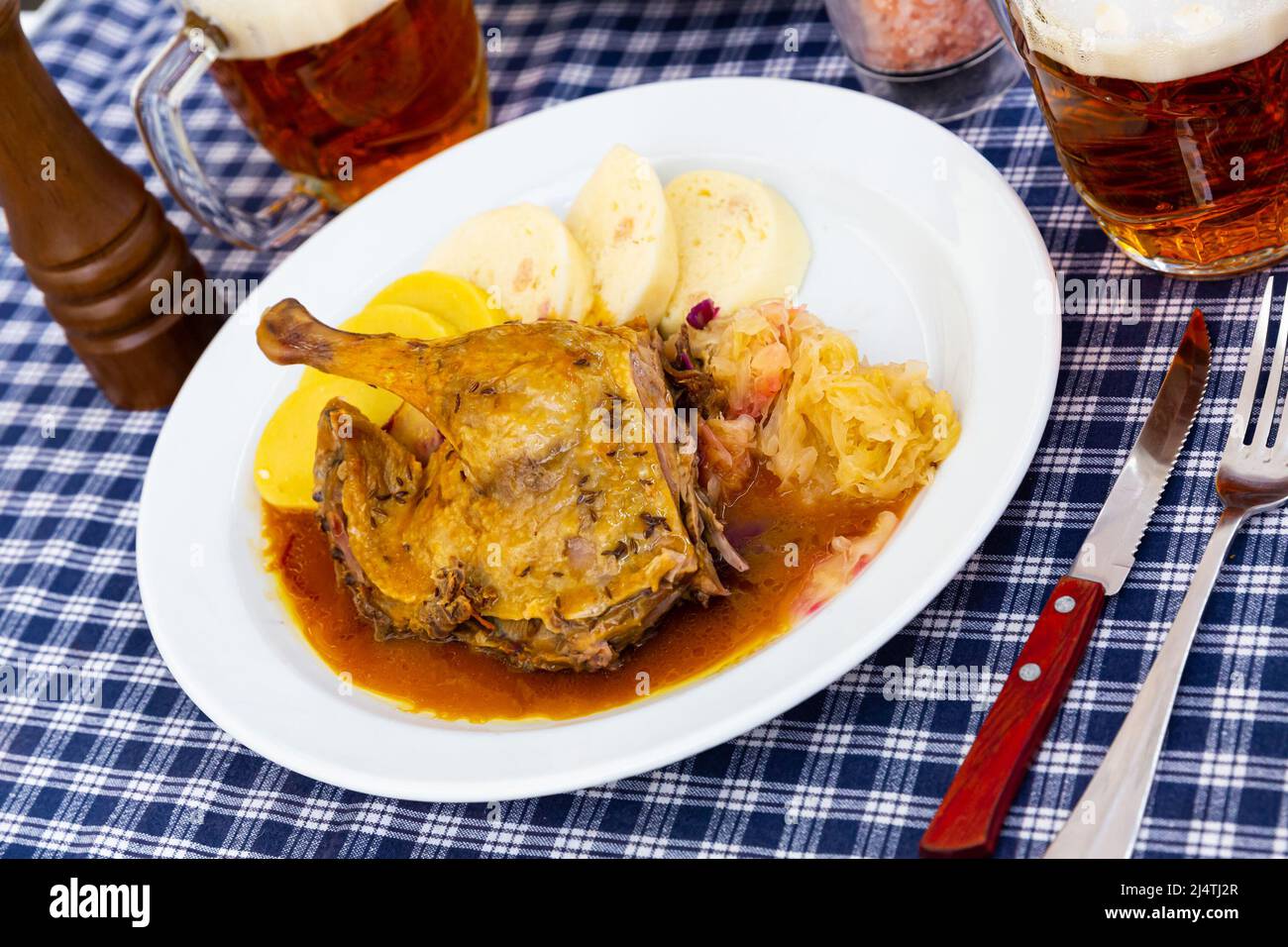 Grilled duck leg quarter with red and white cabbage Stock Photo - Alamy