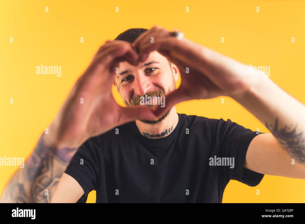 Tattooed European guy with a mustache and a beard wearing black t-shirt ...