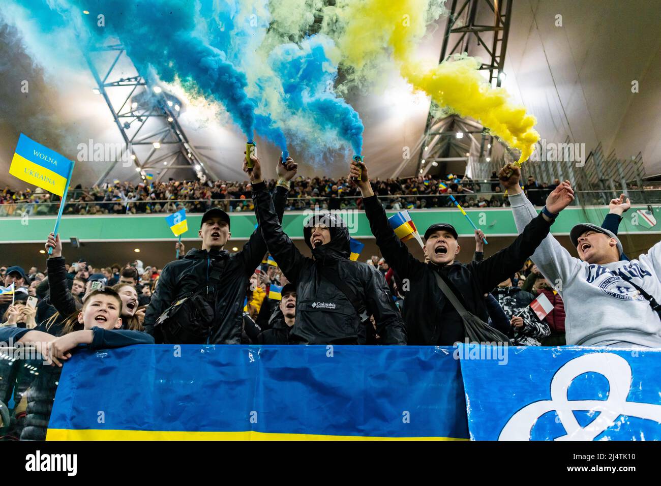 Supporters of Dynamo are holding flares in colors of the Ukrainian flag ...