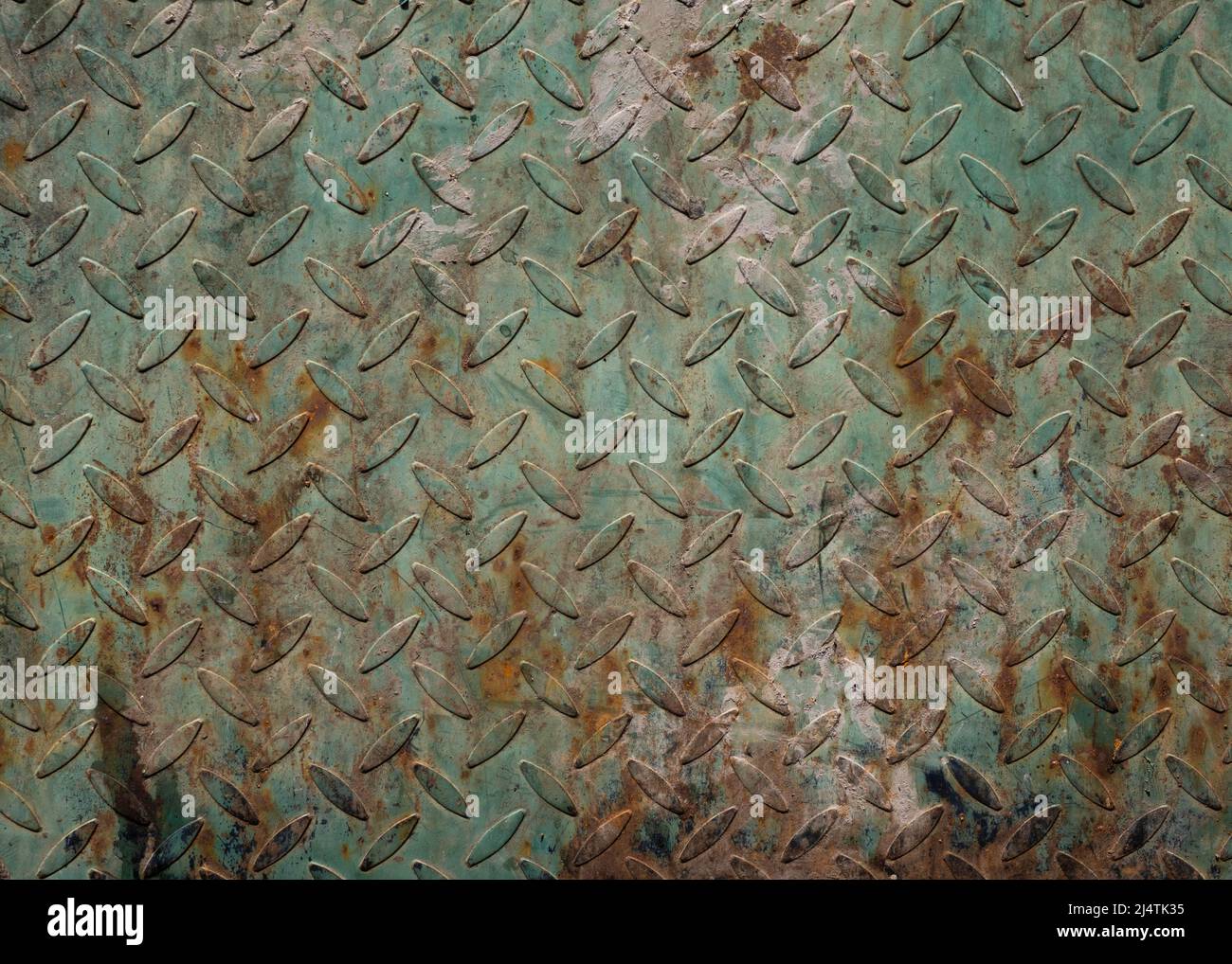 Close up of dirty green and rusted metal sheet with repeated pattern ...