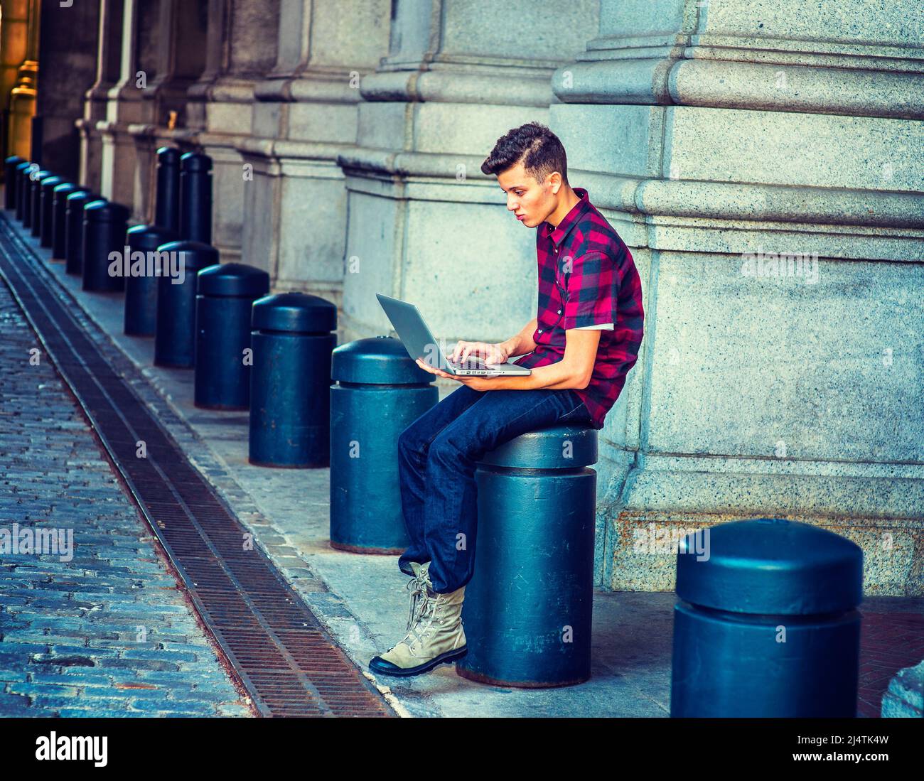 Man Working on street. Wearing a short sleeve, patterned shirt, jeans ...