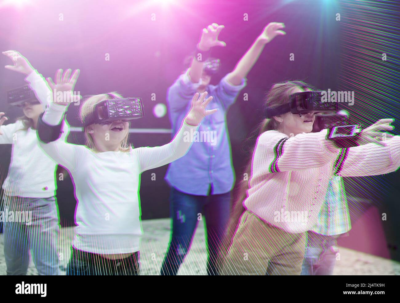 Happy tweens in VR glasses playing virtual reality games, toned image ...