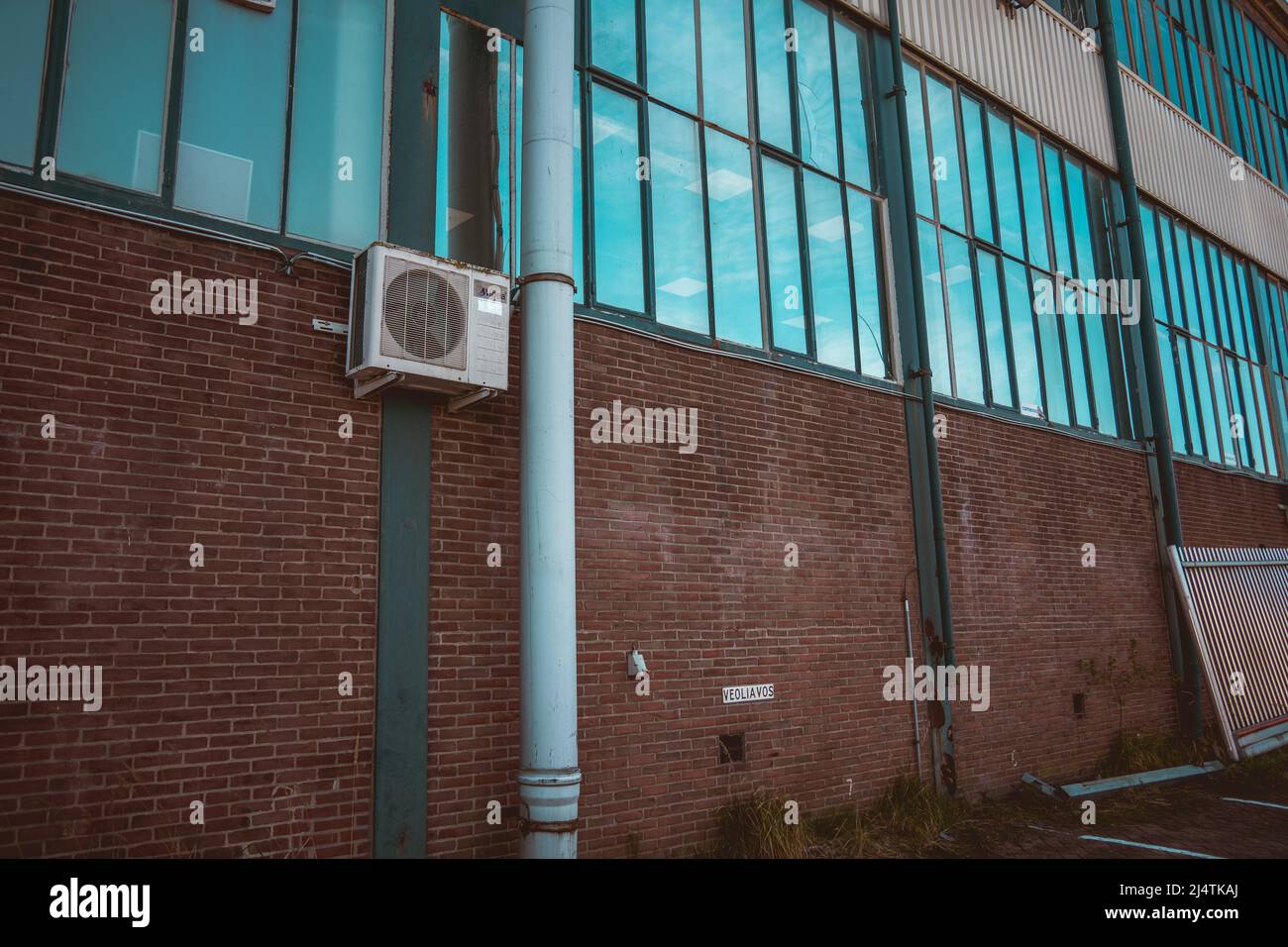 Factory facade reflecting the sky in its windows Stock Photo - Alamy