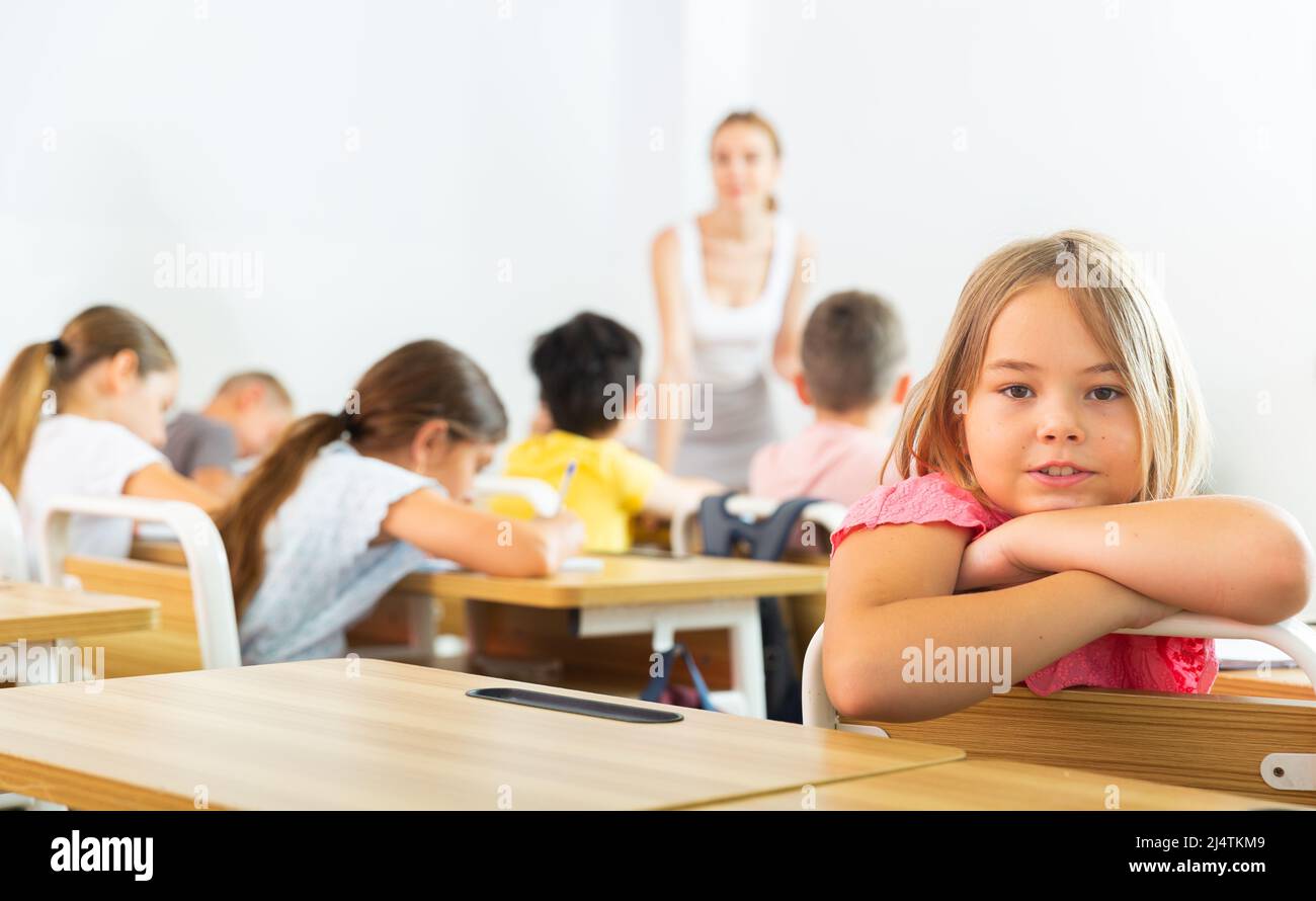 Schoolgirl sitting in classroom Stock Photo - Alamy