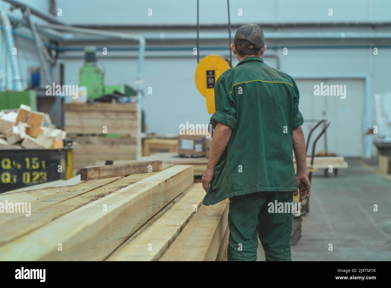 Woodworking worker in factory with stack of wood Stock Photo - Alamy