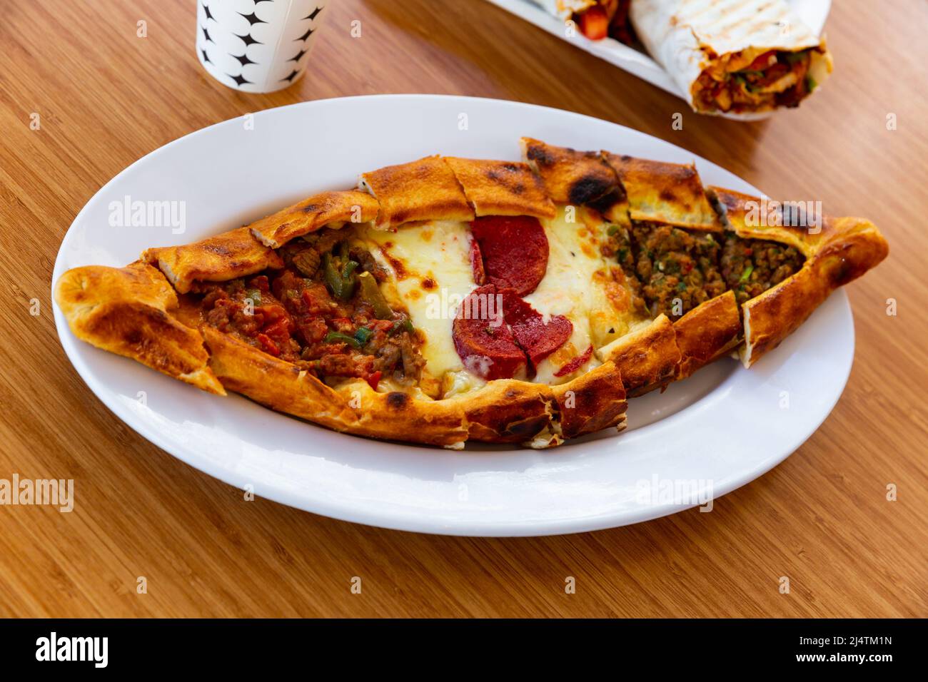 Pide, Turkish flat bread with mixed filling Stock Photo - Alamy