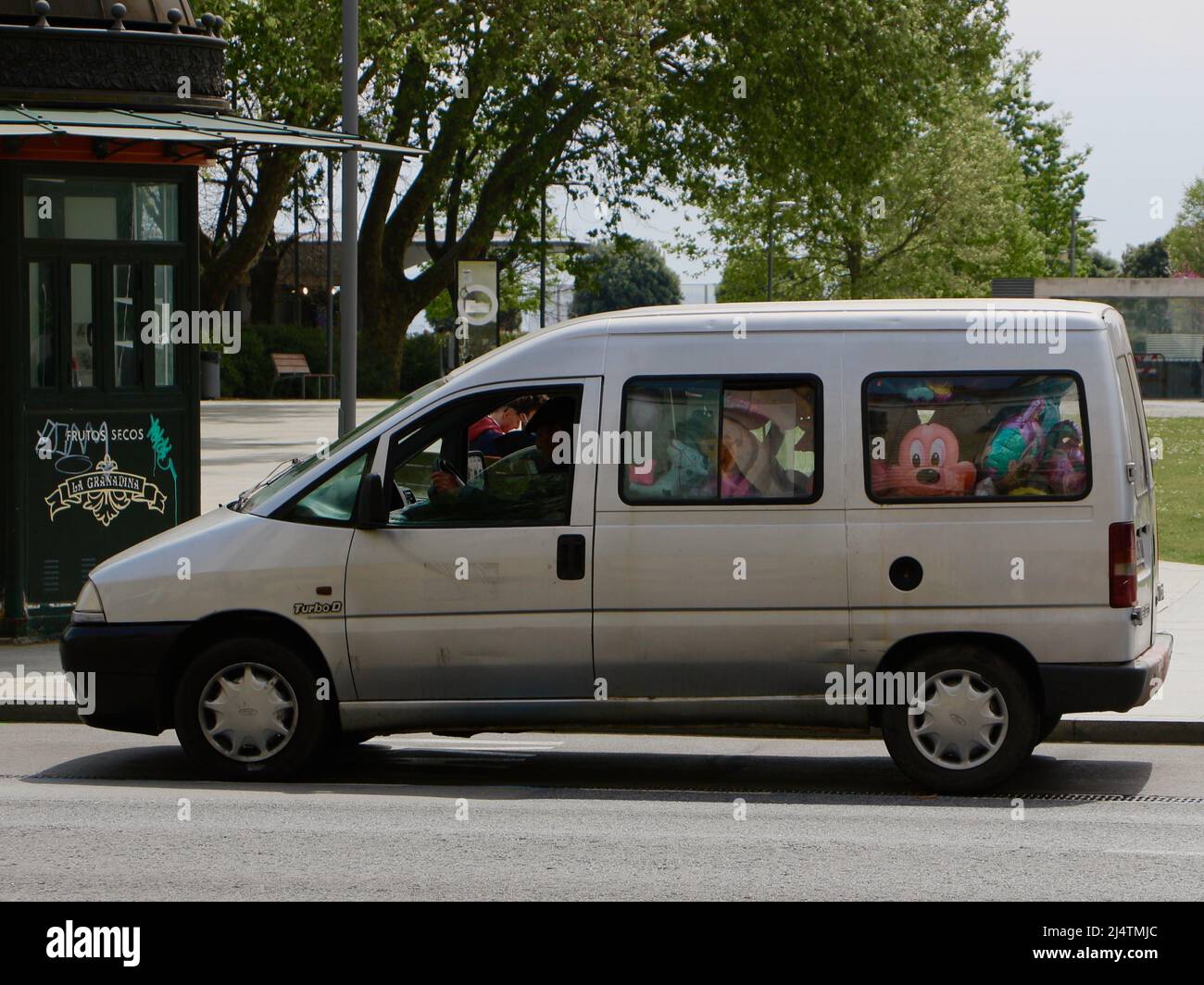 Old silver Peugeot Expert van with helium filled balloons and a Mickey ...