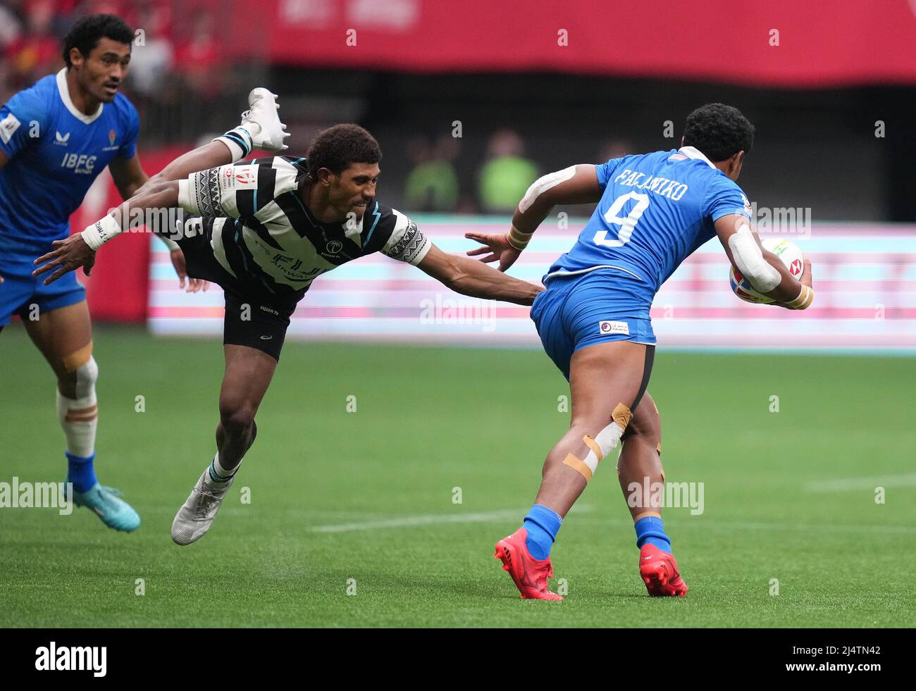 Samoa's Faafoi Falaniko, right, gets away from a tackle by Fiji's ...