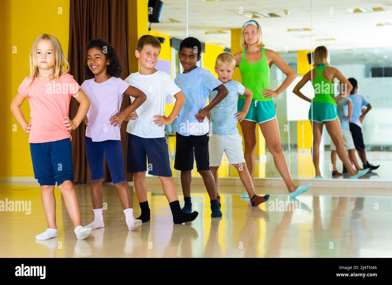 Cheerful little children studying modern style dance in class Stock ...