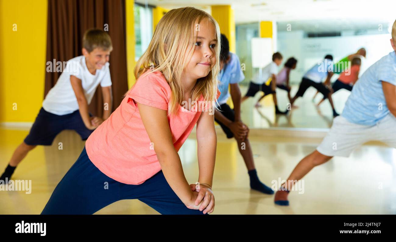 Portrait of smiling children practicing sport dance in modern dance ...