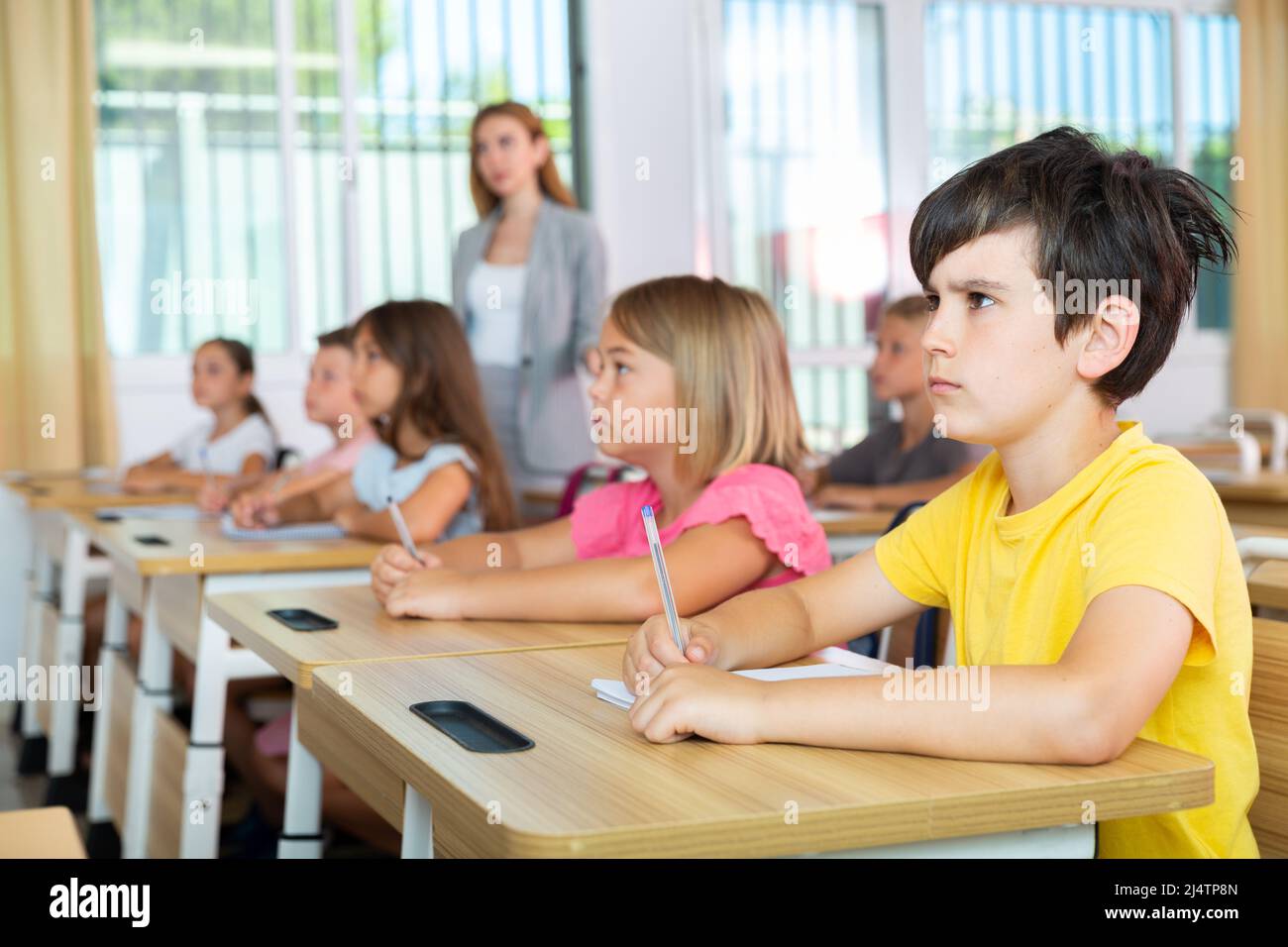 Kids studying in classroom Stock Photo - Alamy
