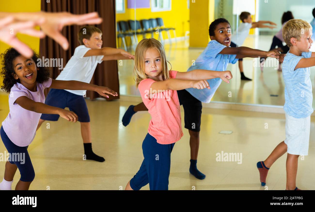 Portrait of smiling children practicing sport dance in modern dance ...