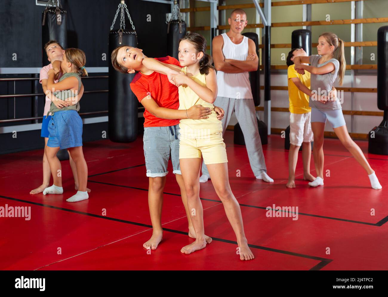 Kids in pairs training elbow strike Stock Photo - Alamy