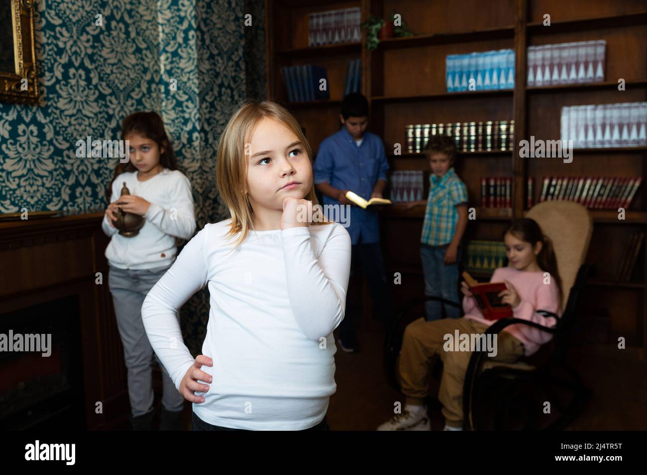 Thoughtful preteen girl solving puzzle in escape room Stock Photo - Alamy