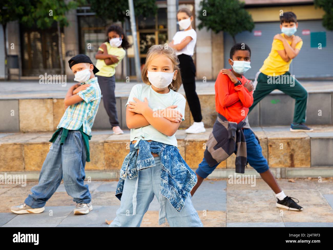 Kids in masks dancing on street Stock Photo - Alamy