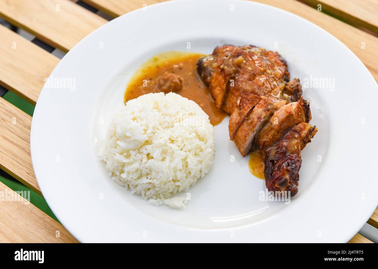 Thai rice food, cooked white rice and grilled chicken with sauce on ...