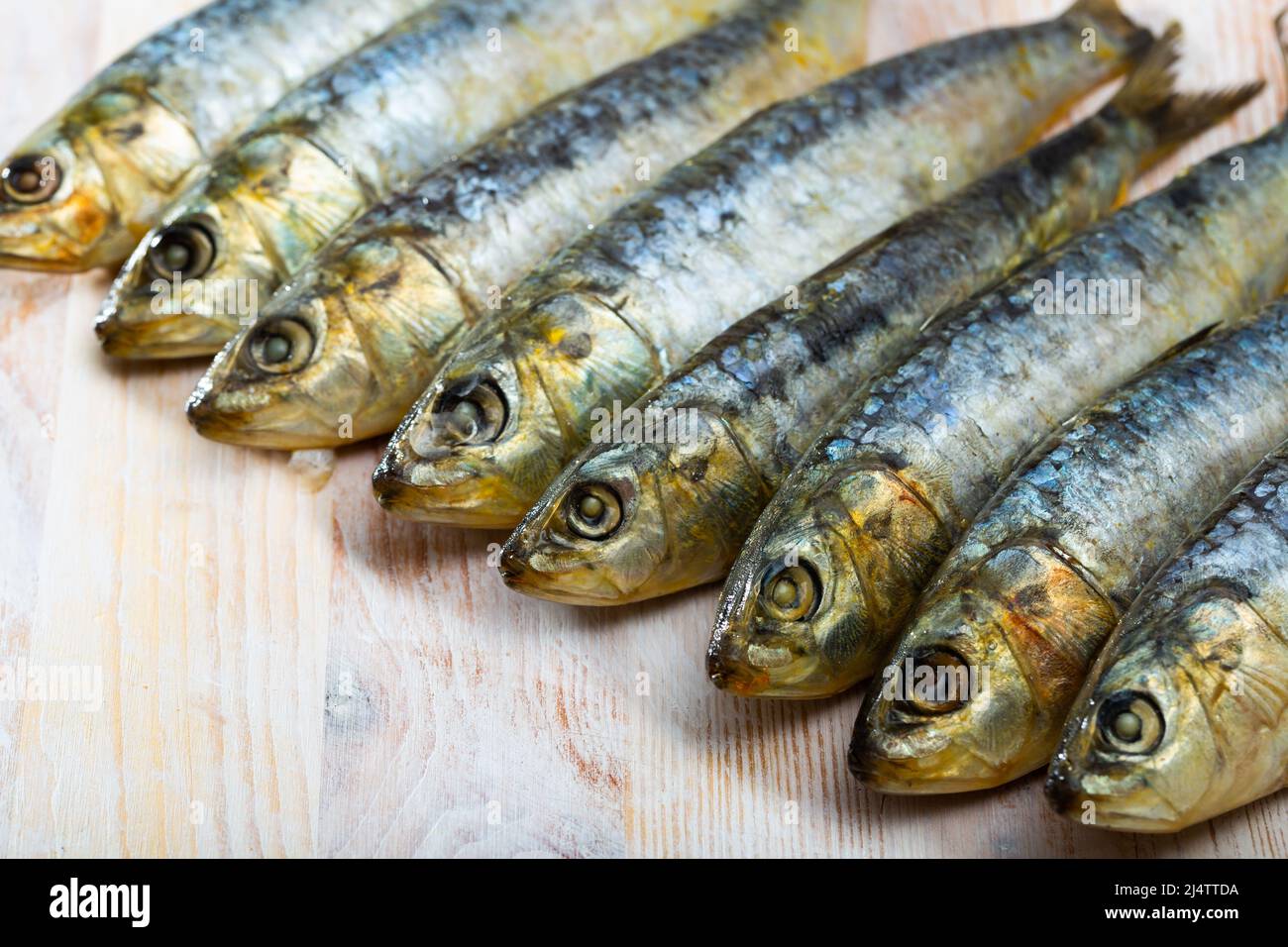 Marinated sardines on wooden table Stock Photo - Alamy