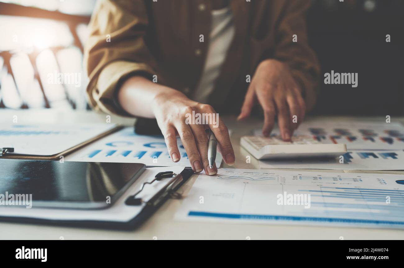 Close up of business woman or accountant working on calculator to ...