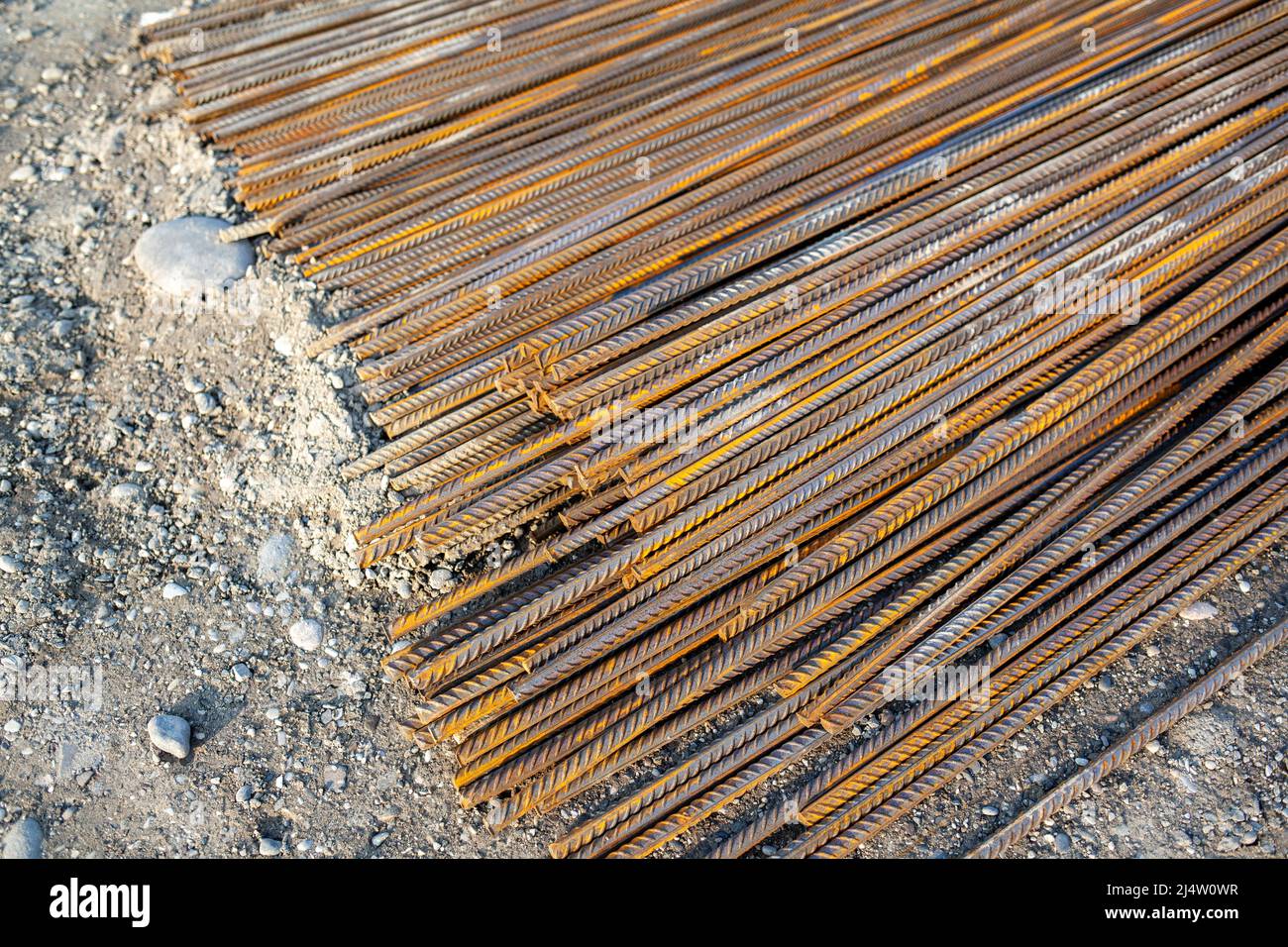 Stack of rusty iron rods or bars. Old metal rusty or steel rod. A lot ...