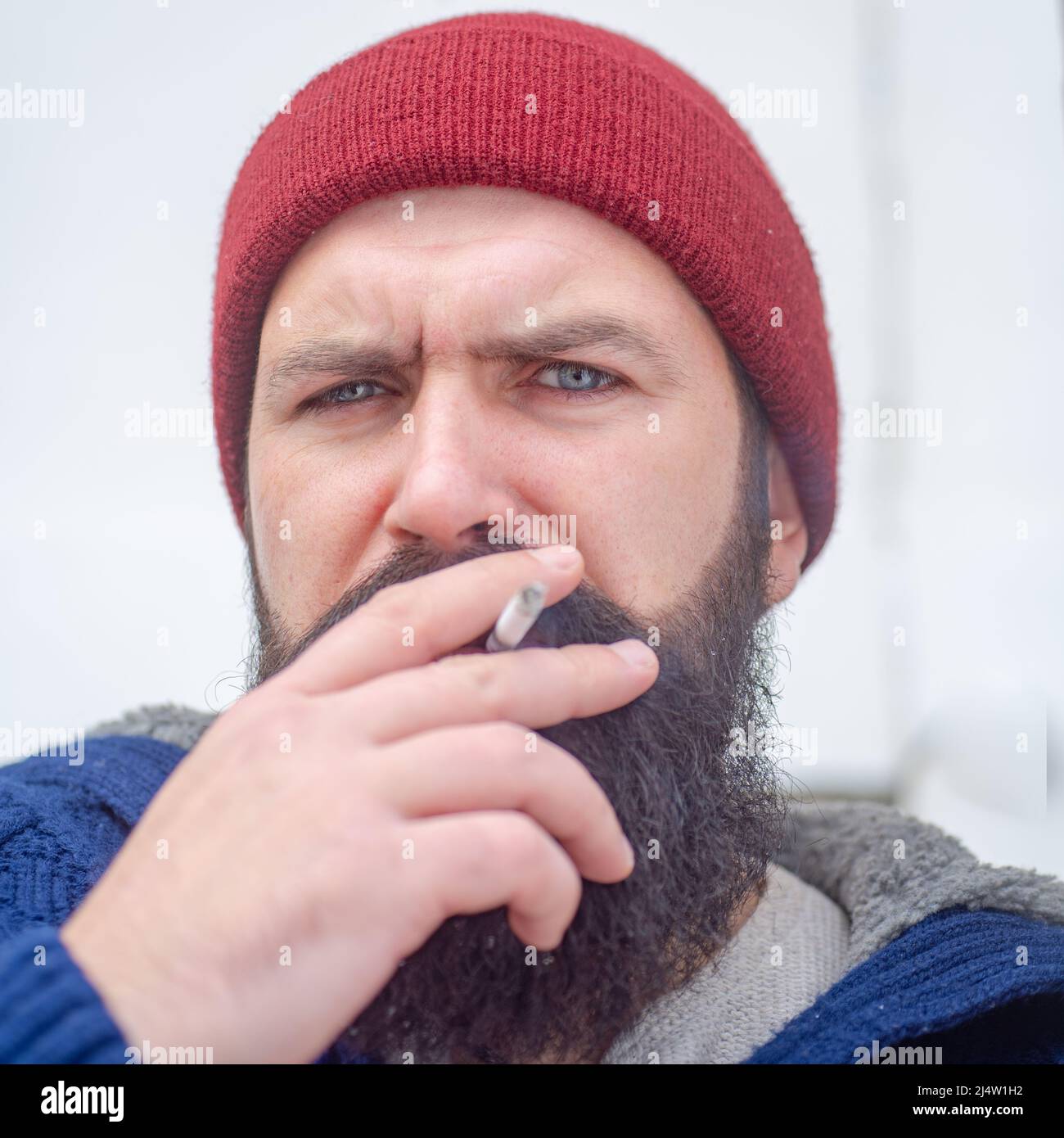 Cigarette nicotine addiction. Hipster brutal man smoking cigarette ...