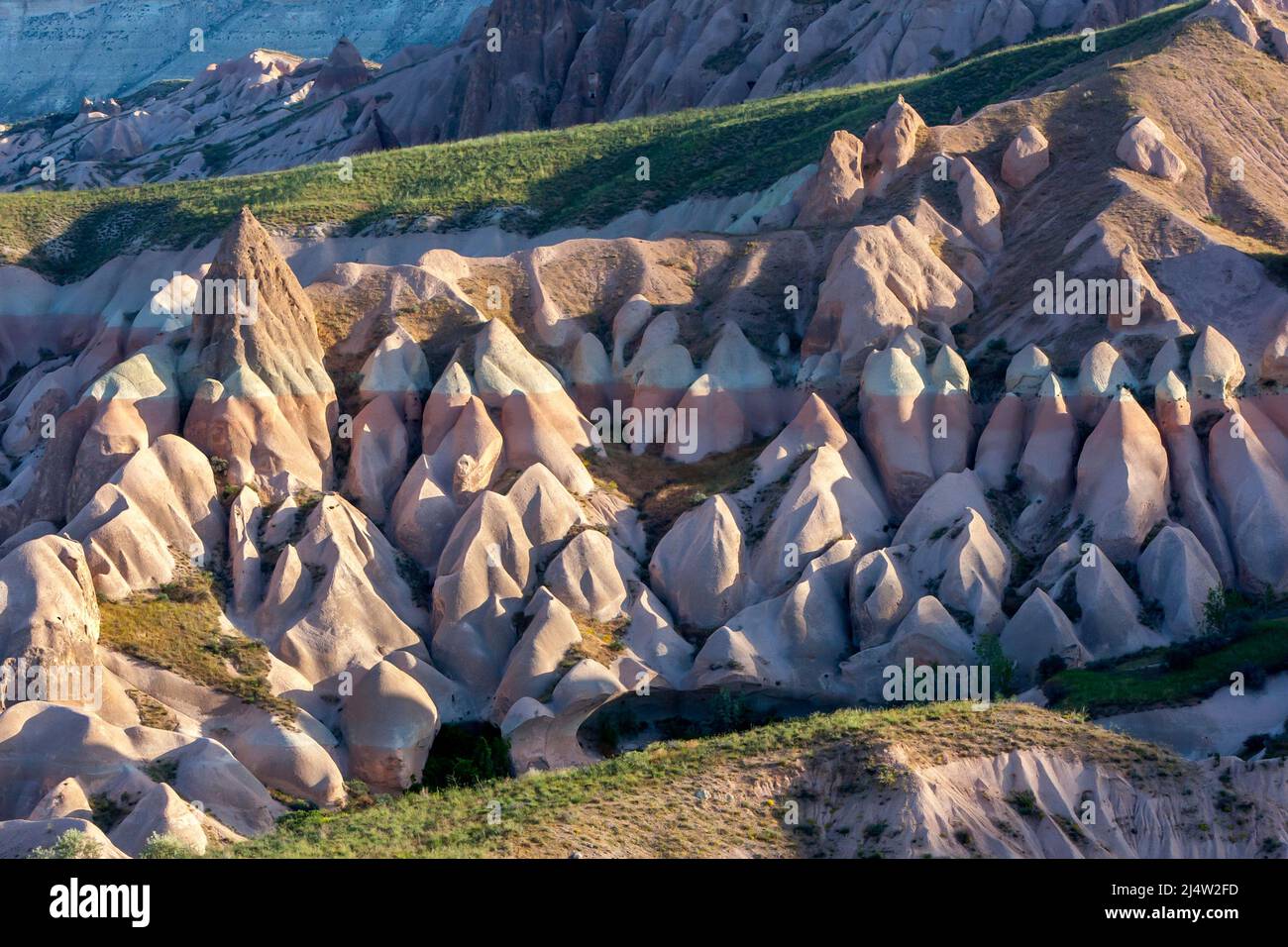 The incredible layers of coloured tuff rock on an eroded hillside near ...