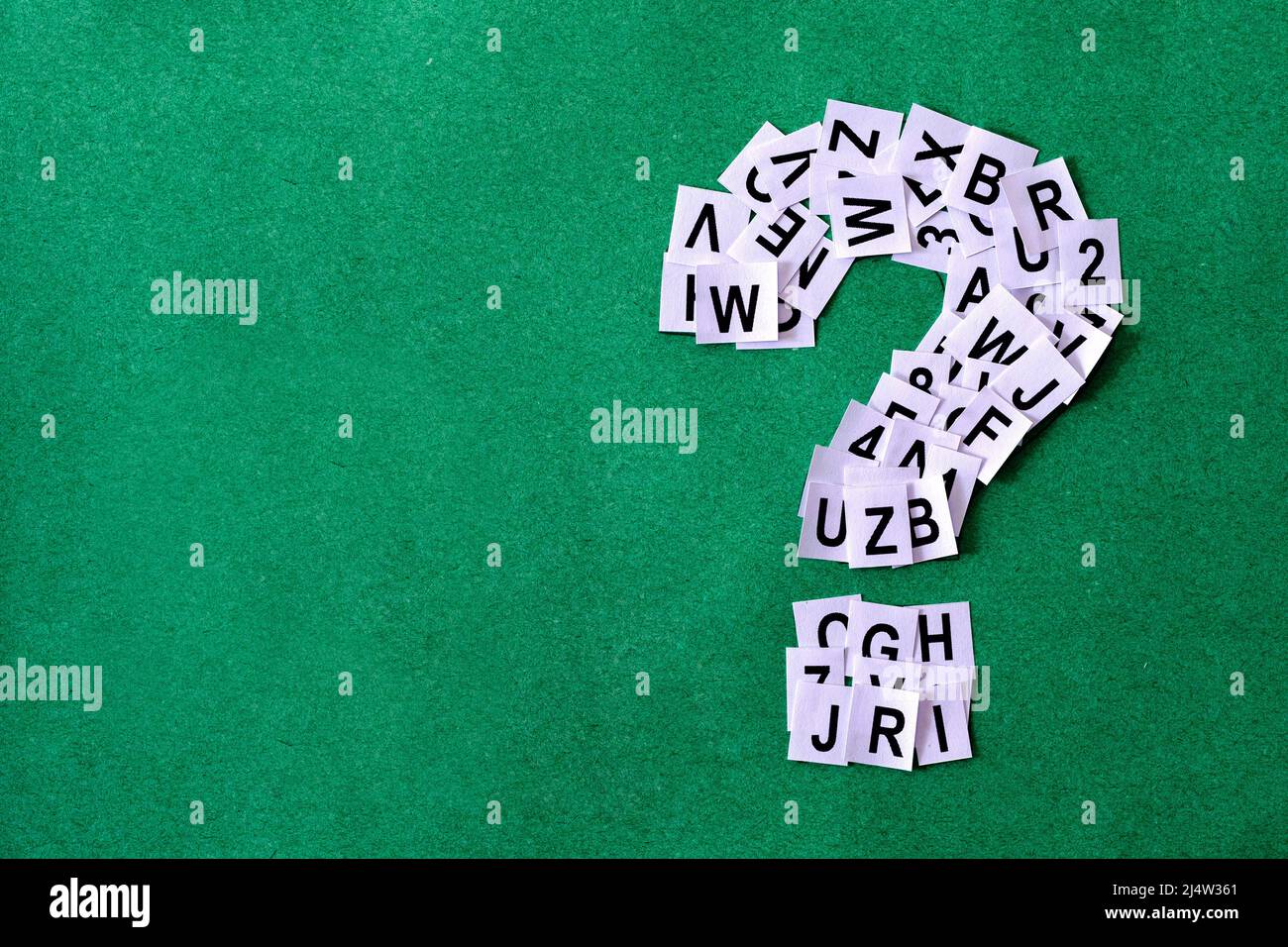 Question mark on green background with copy space made of paper with ...