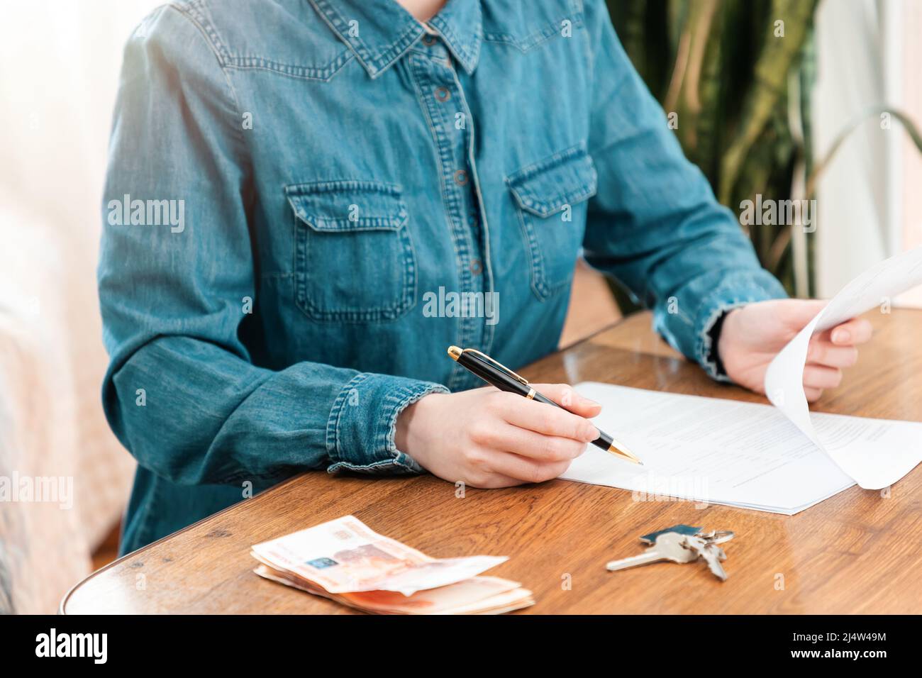 Realtor fills out a contract for the lease or purchase of real estate ...