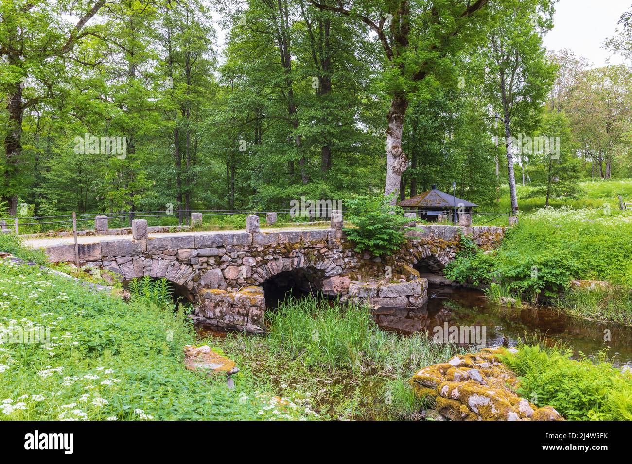 Old arch bridge over a stream Stock Photo - Alamy