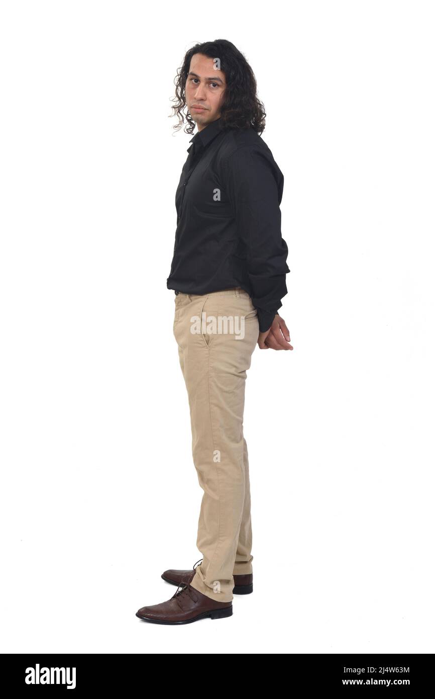 side view of a man with long hair looking at camera on white background ...