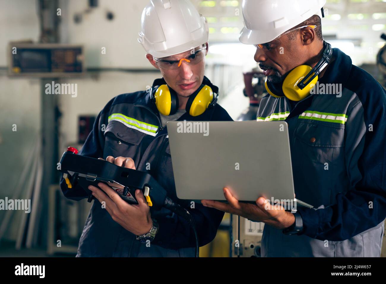 Group of factory job workers using adept machine equipment in a ...
