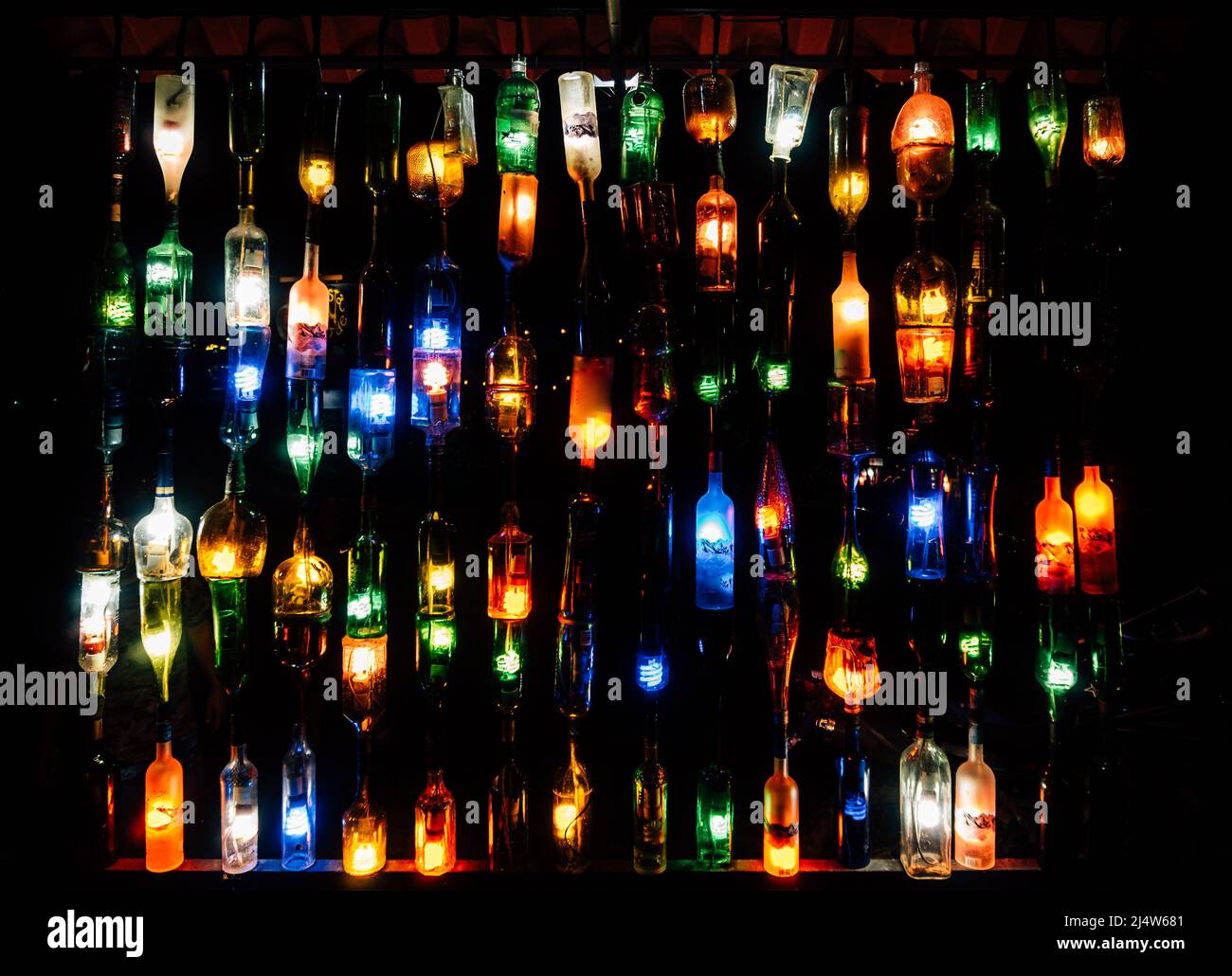 Light bulbs inside decorative glass bottles of different colors Stock ...