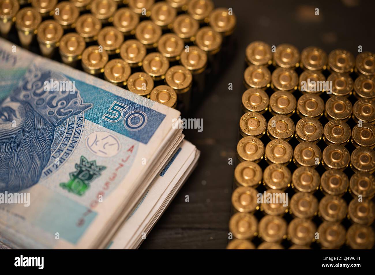 Military transaction. Small arms ammunition and a bundle of bank bills ...