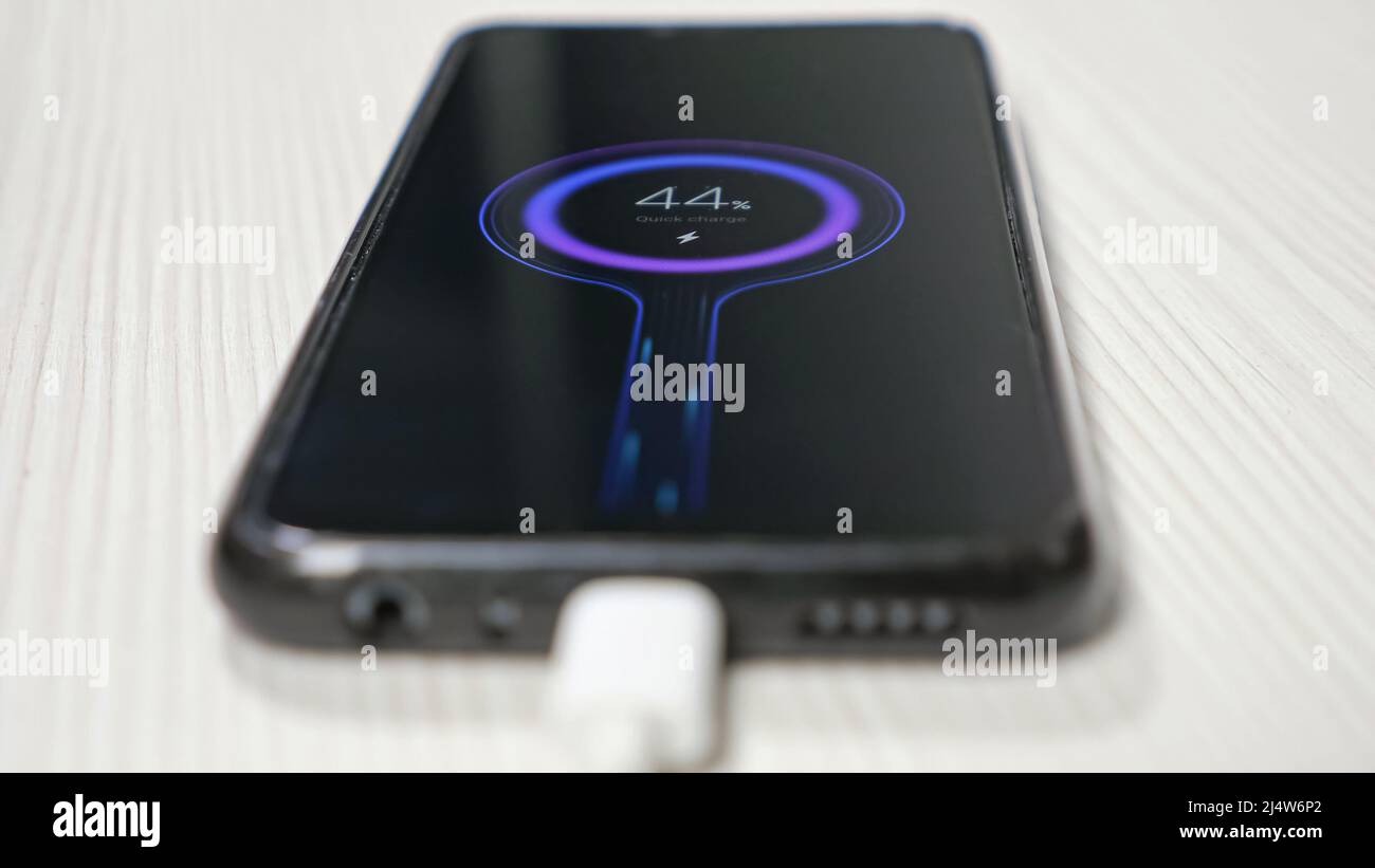 the phone lie on the table charging fast connection to your phone by ...