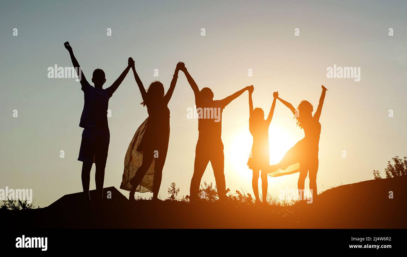 happy family parents holding hands raised their hands up. dad mom ...
