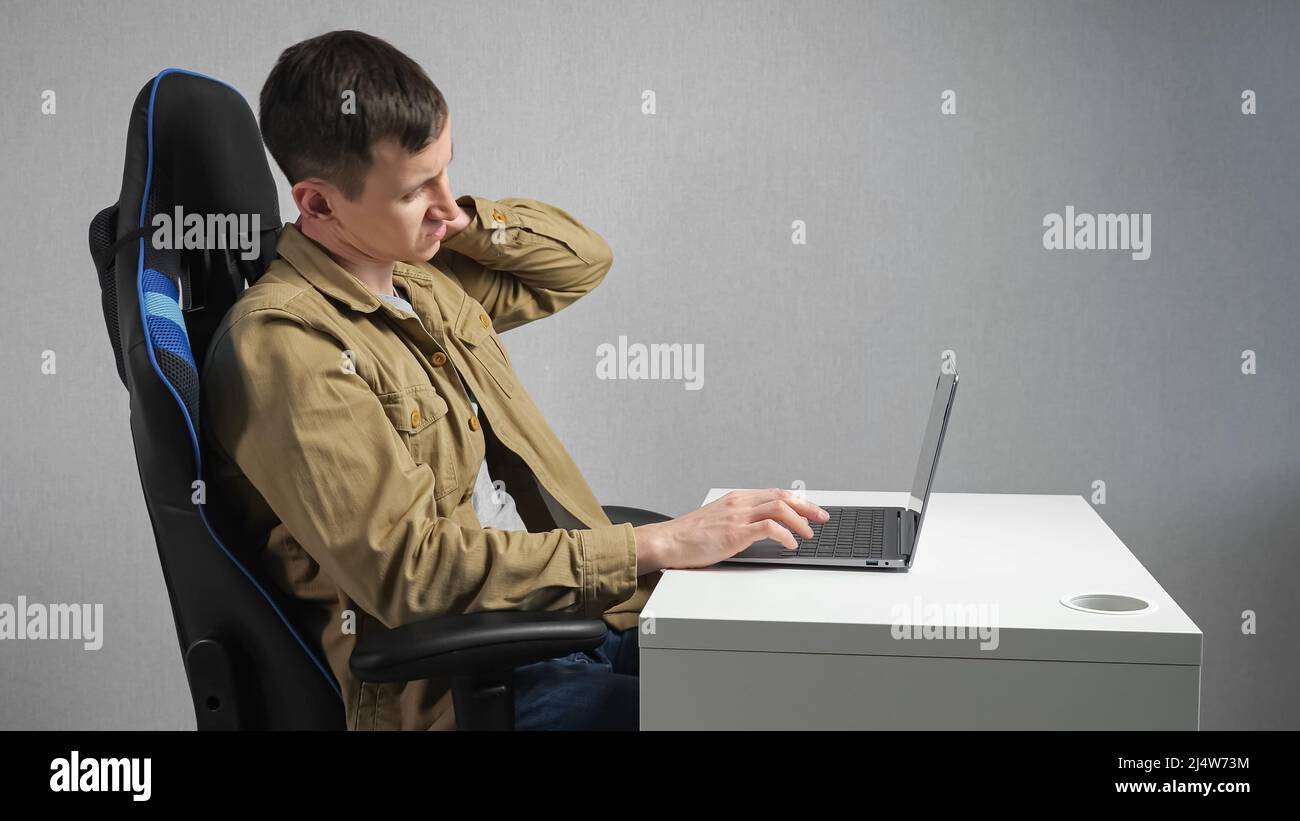 Young freelancer feels uncomfortable fidgeting in armchair Stock Photo ...