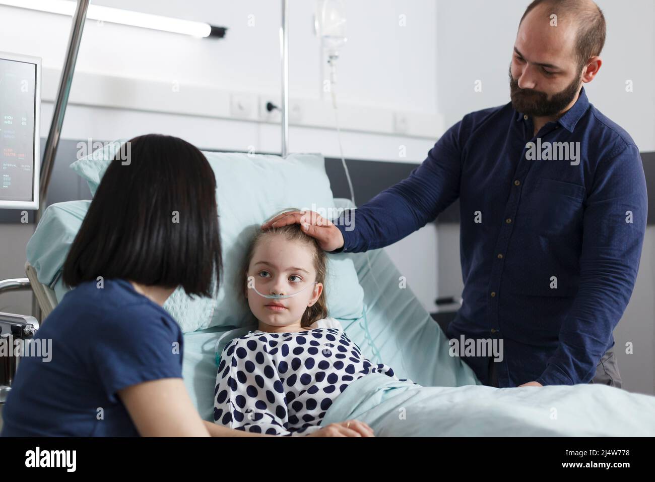 Careful parents talking with sick daughter about recovery period. Young ...