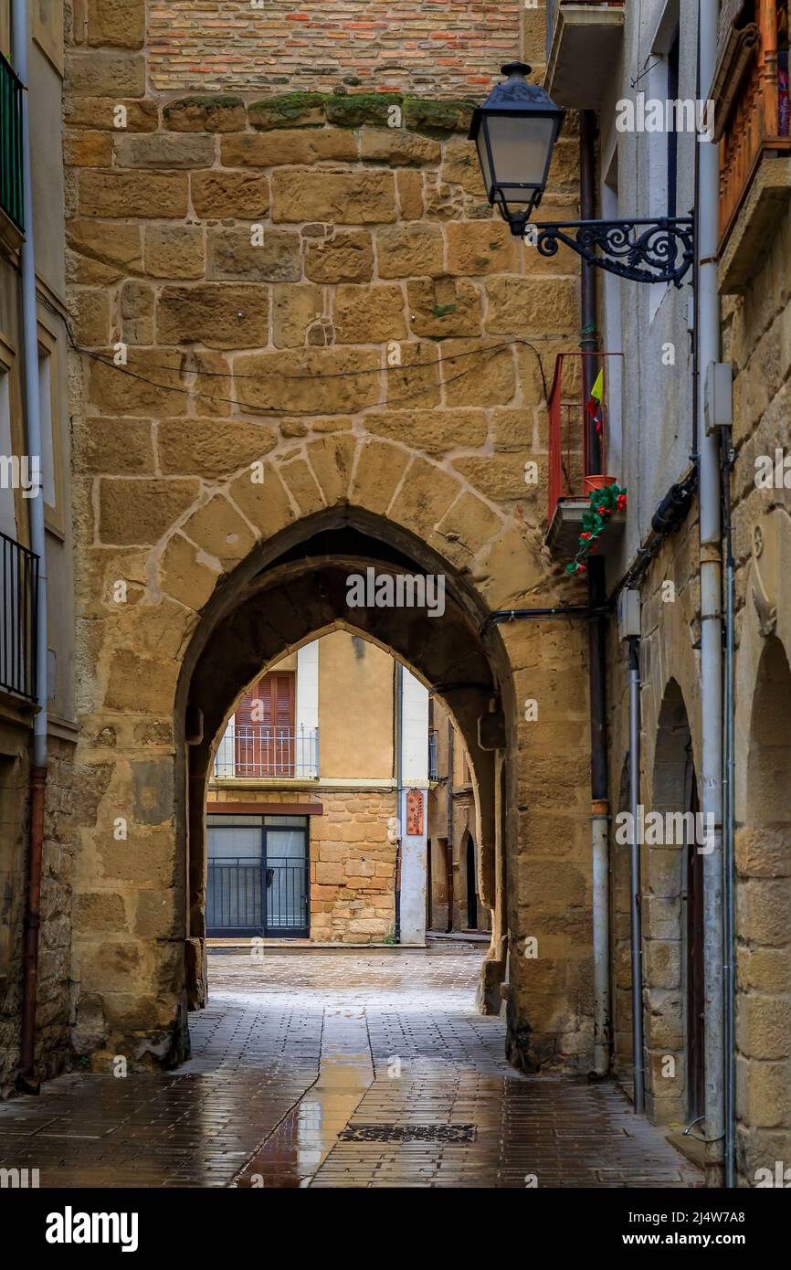 Rustic medieval stone archway in a street in Olite, Spain famous for a ...
