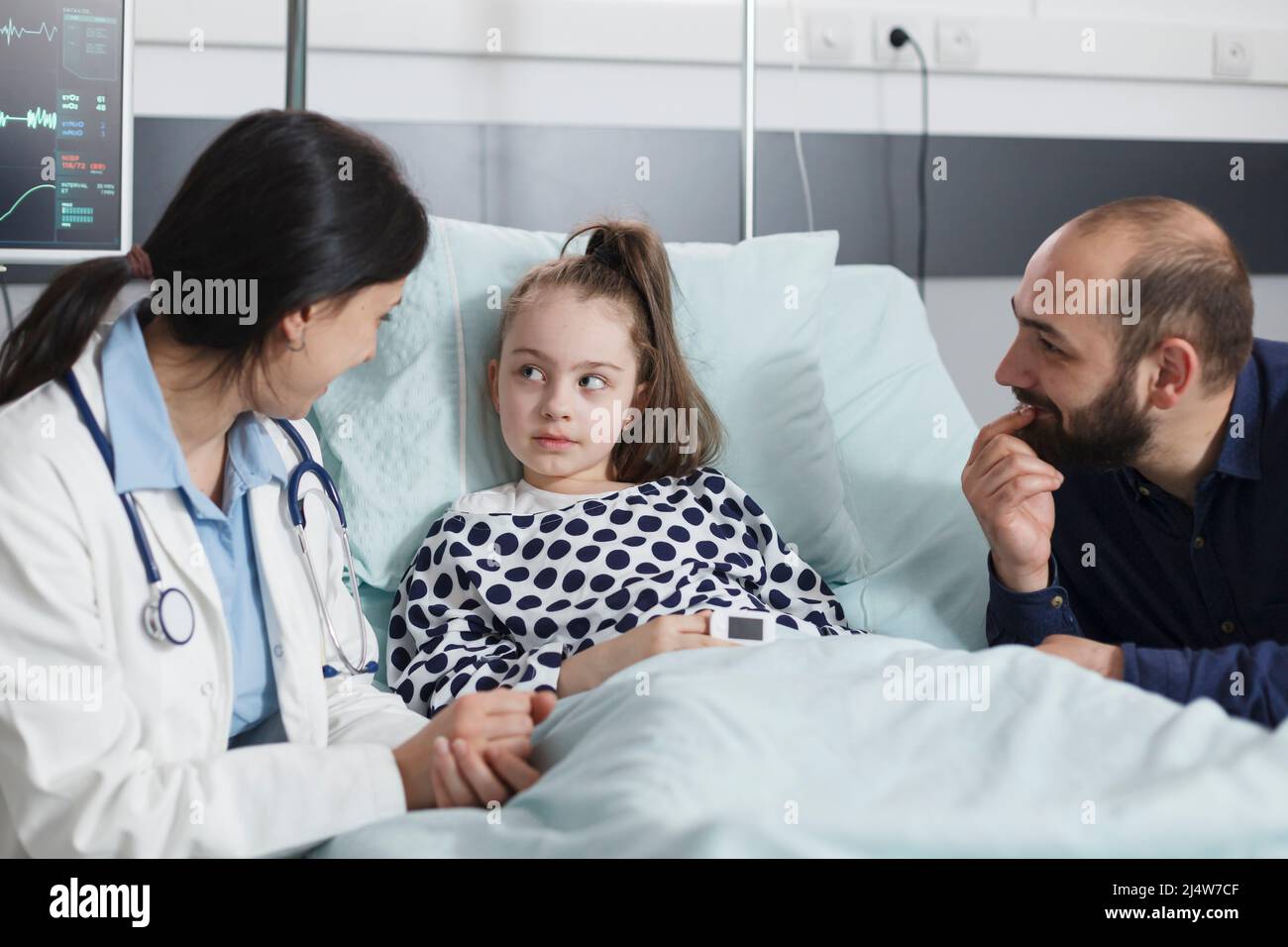 Happy smiling father being attentive to pediatrist expert talking about ...